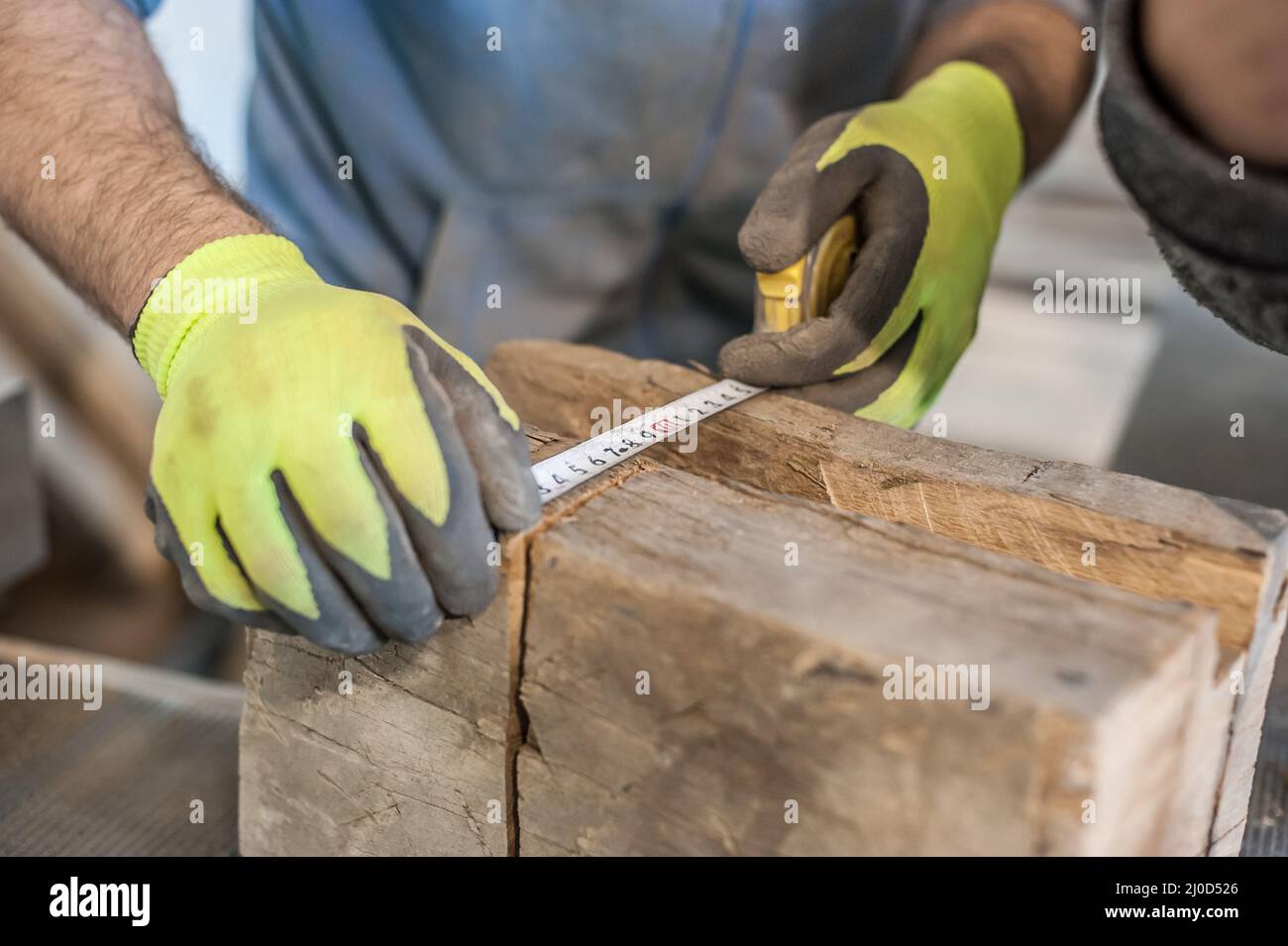 Construction Worker Using Tape Measure. Professional carpenter at work ...