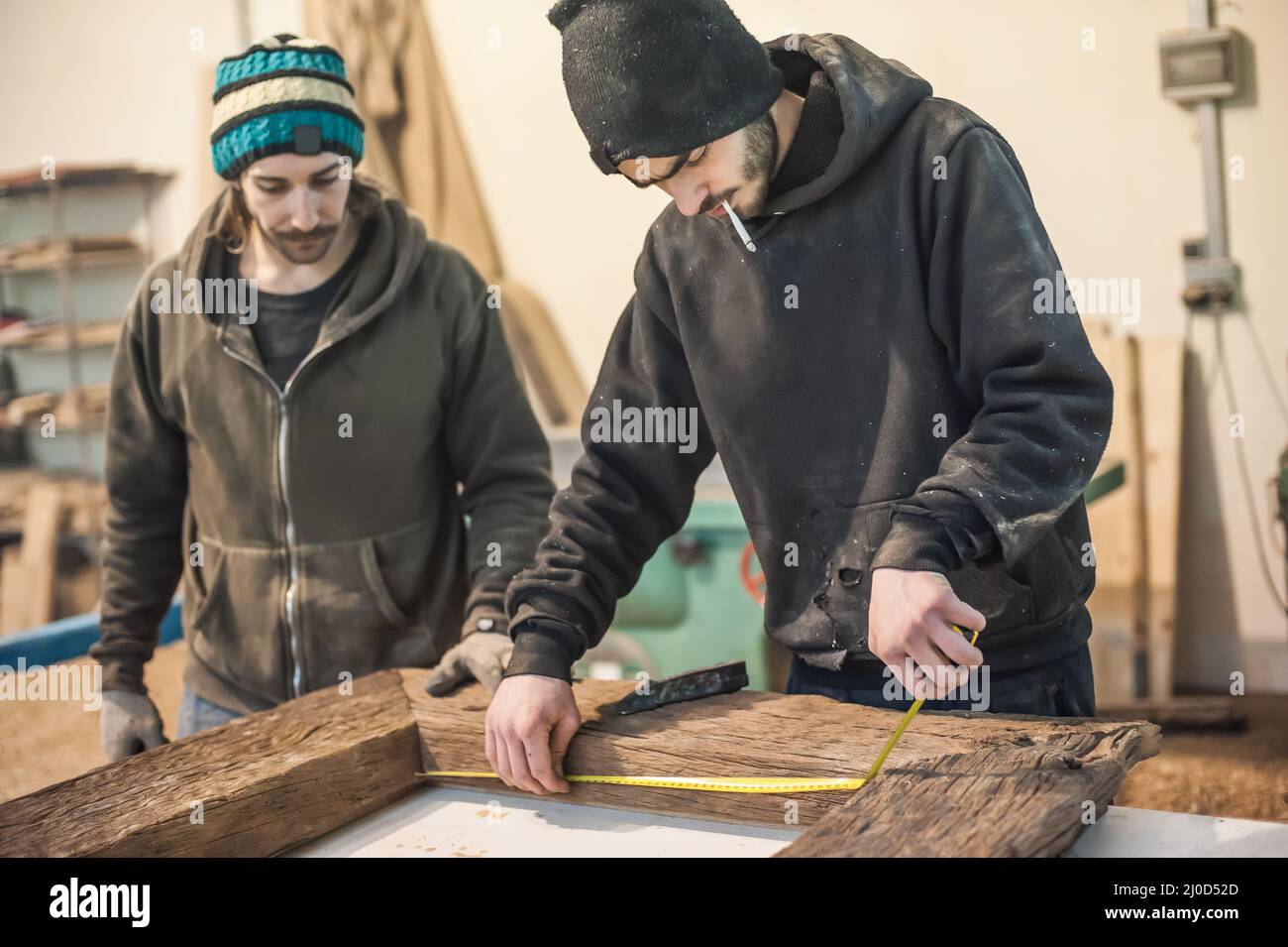 Professional carpenter at work measuring wooden planks Stock Photo - Alamy