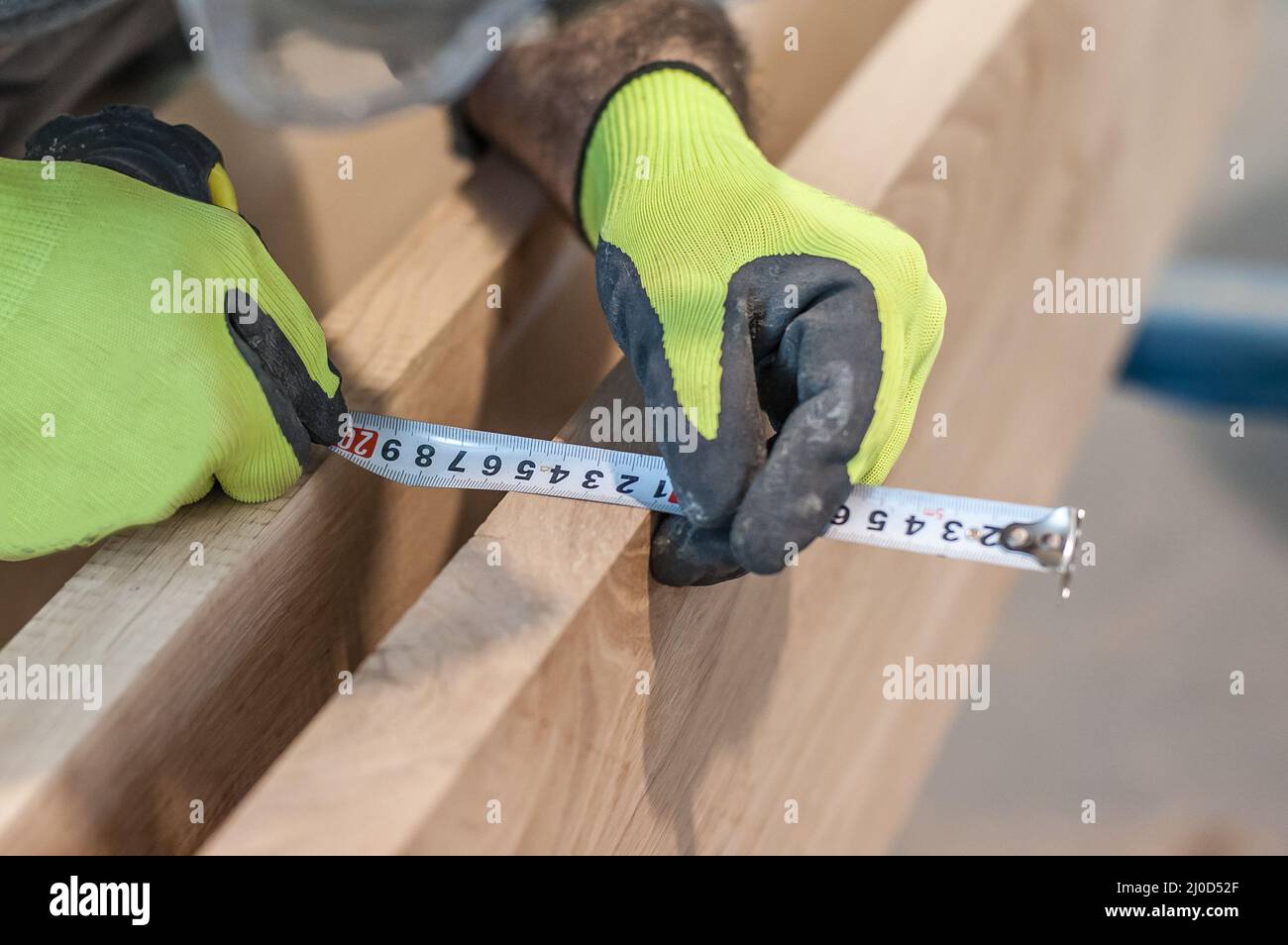 Professional carpenter at work measuring wooden planks Stock Photo - Alamy