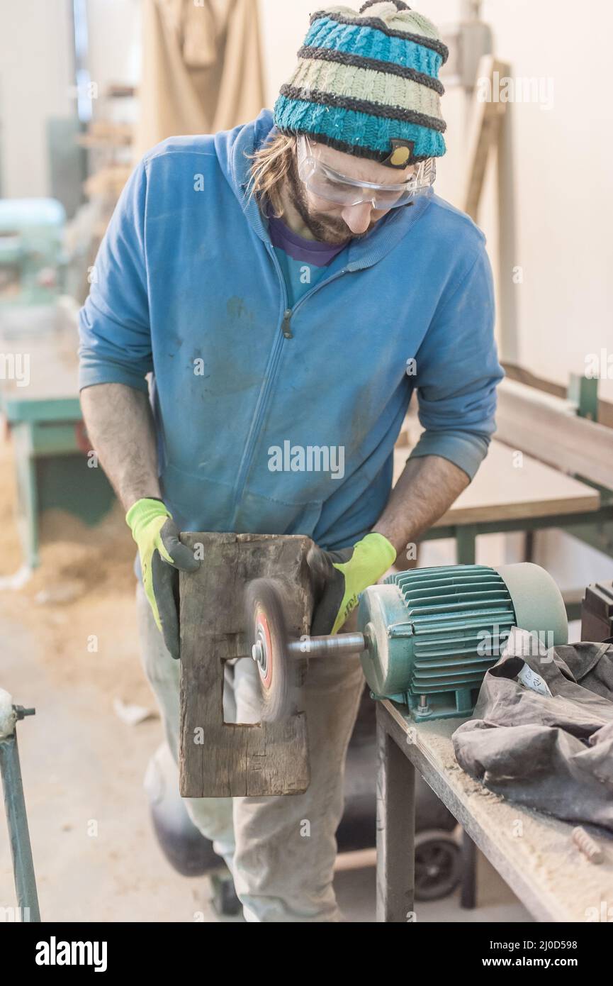 Carpenter Using Electric Sander. Carpenter sanding a wood with sander ...