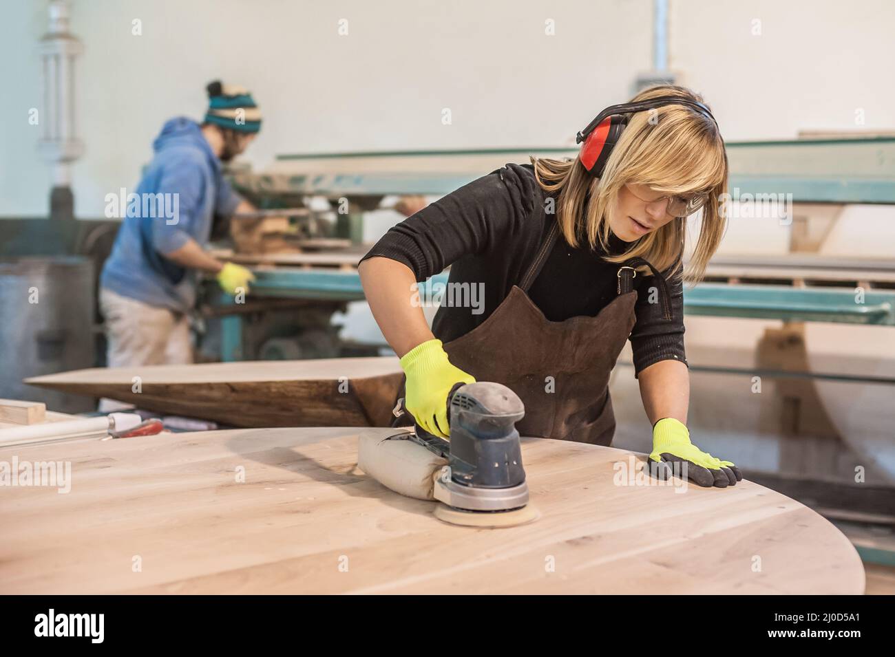 Female carpenter Using Electric Sander for wood Stock Photo - Alamy