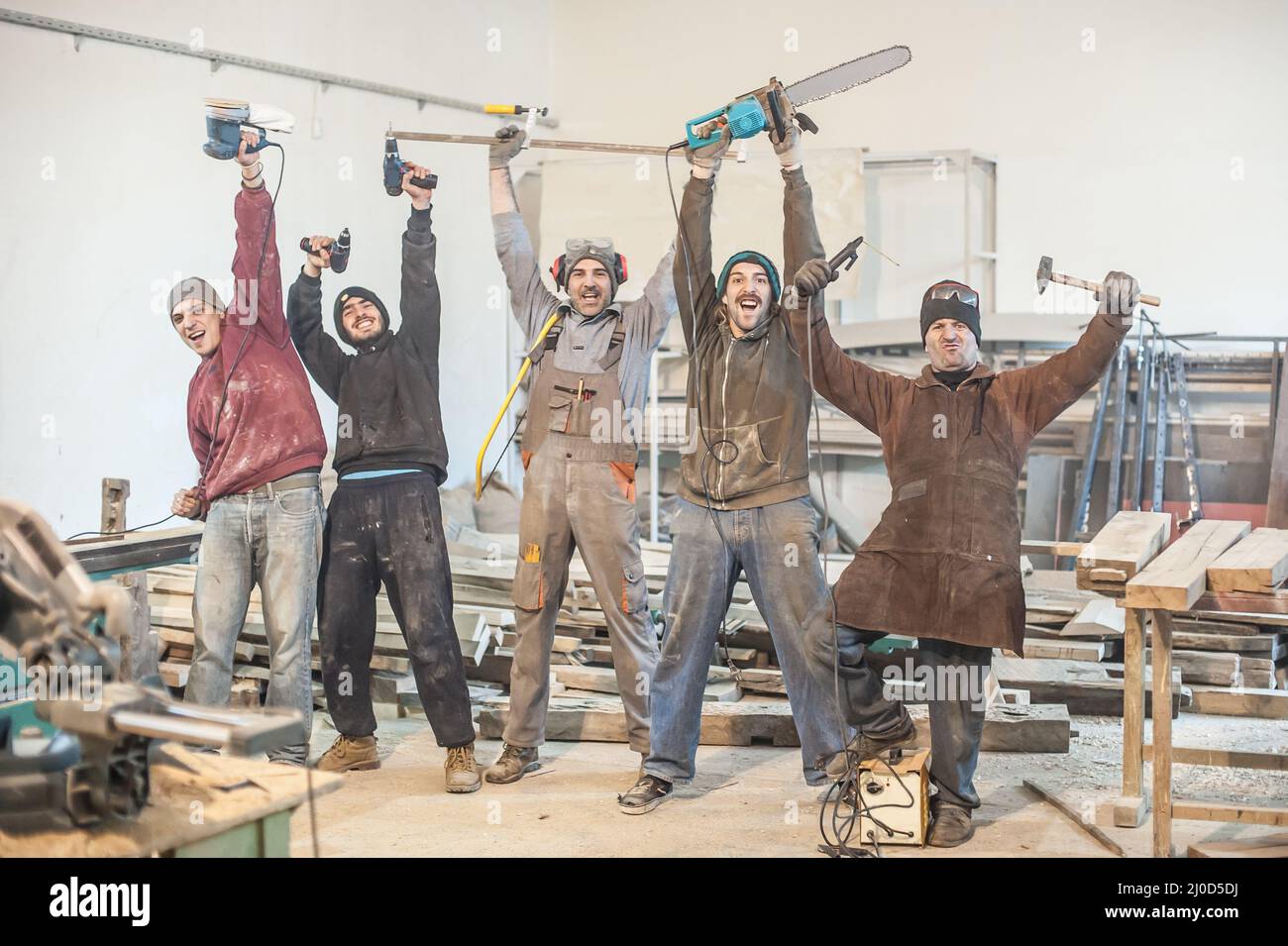 Funny Workers. Workers posing with their tools in the workshop Stock ...