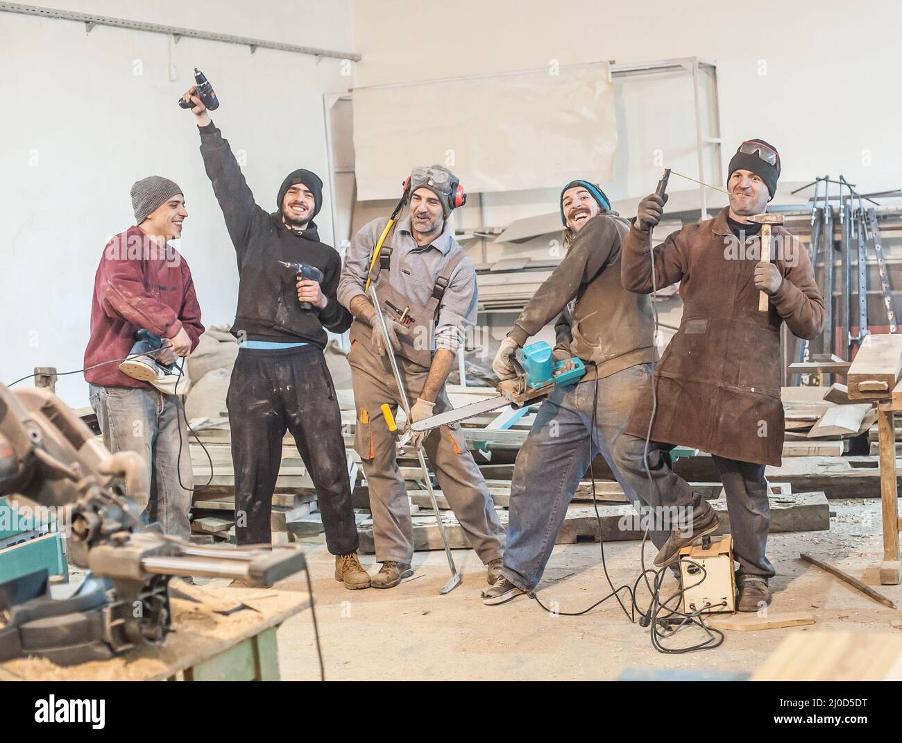 Funny Workers. Workers posing with their tools in the workshop Stock ...