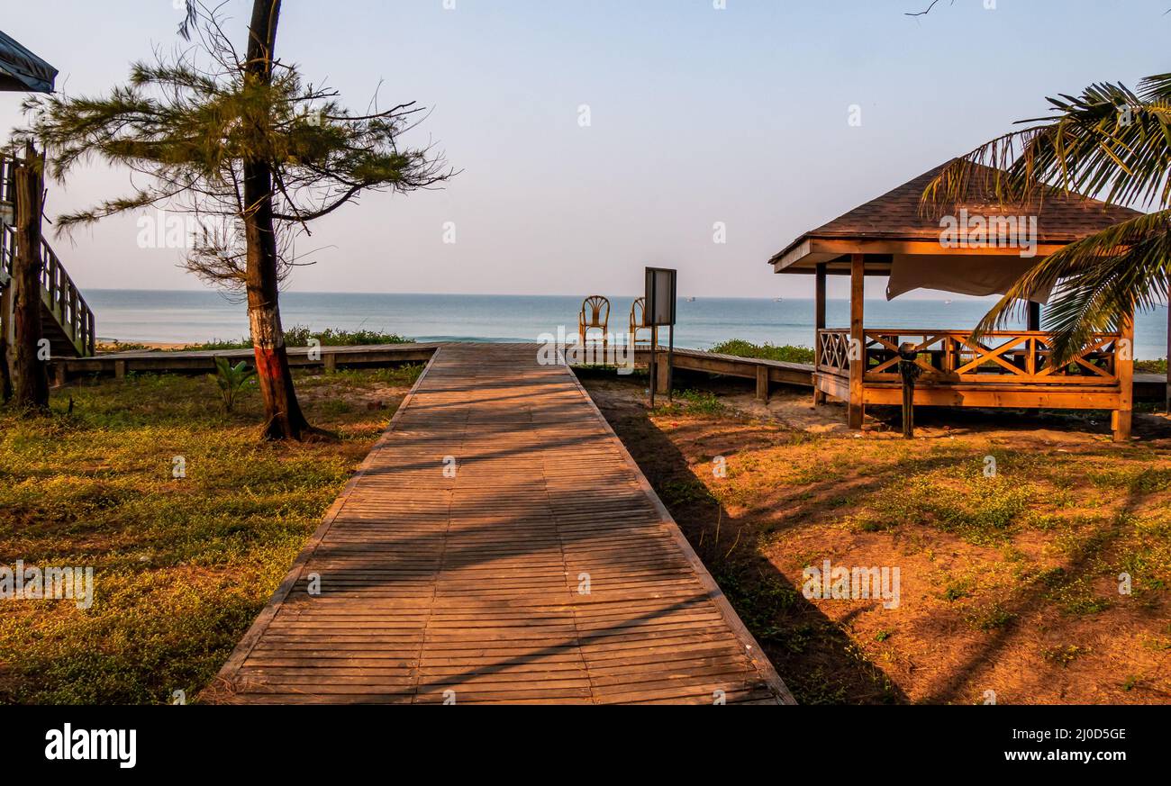 View to a long wooden pier and wooden shacks going to the sea at ...