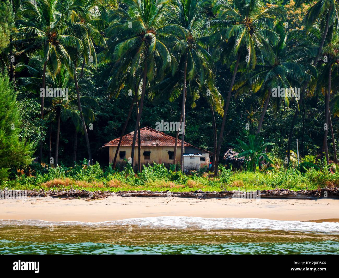 Indian house with traditional roof design at beach side of Maharashtra ...