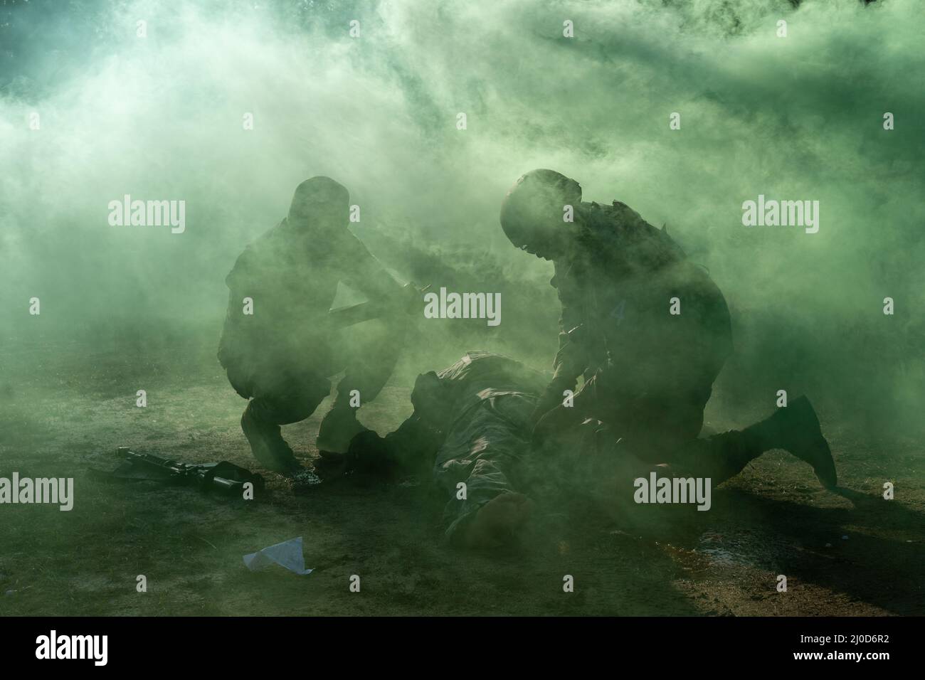 Military army during the combat training surrounded with green smoke in ...