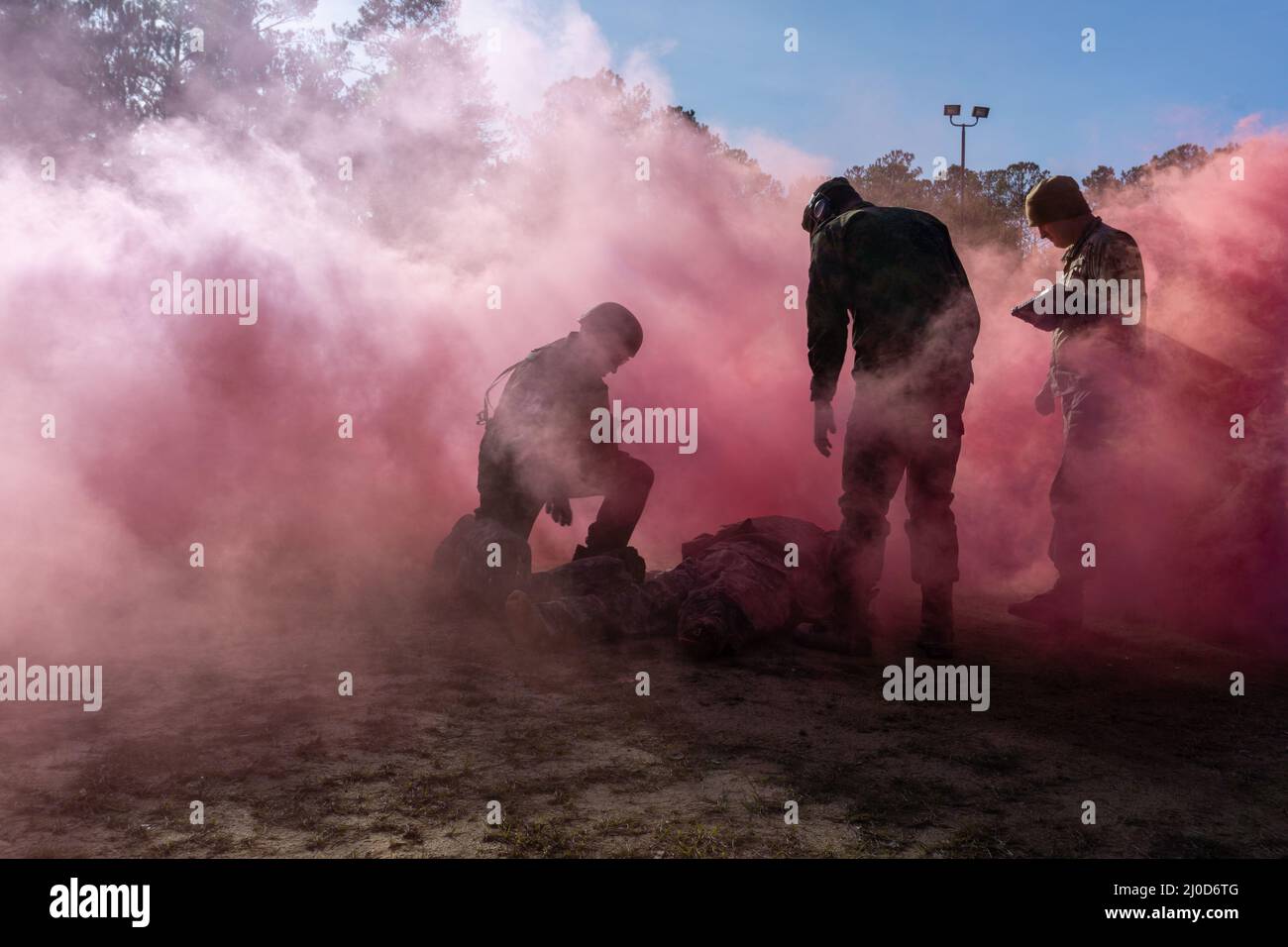 Military army during the combat training surrounded with pink smoke in ...