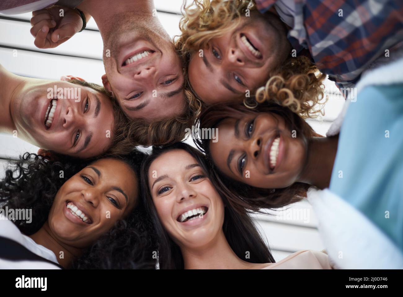 Enjoying campus life. Low angle shot of young university students ...