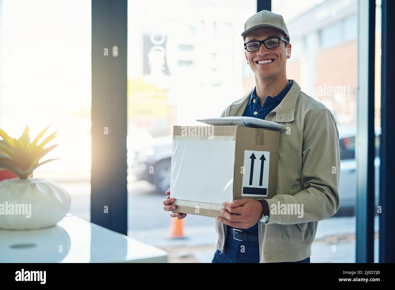 Your package has safely arrived. Portrait of a courier making a ...