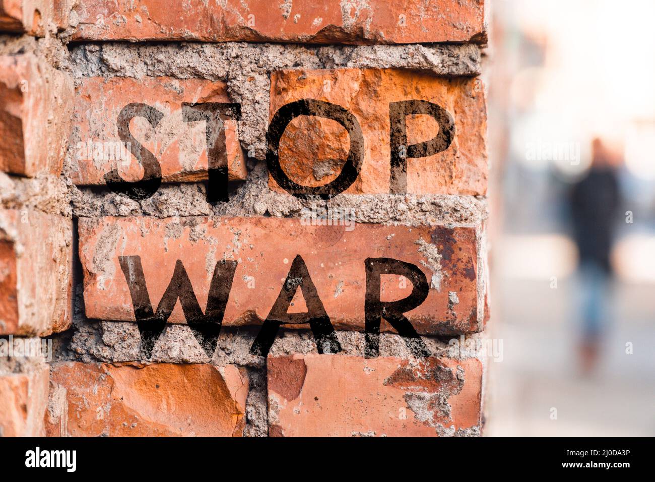 The inscription on the bricks stop war. The inscription on the wall of ...
