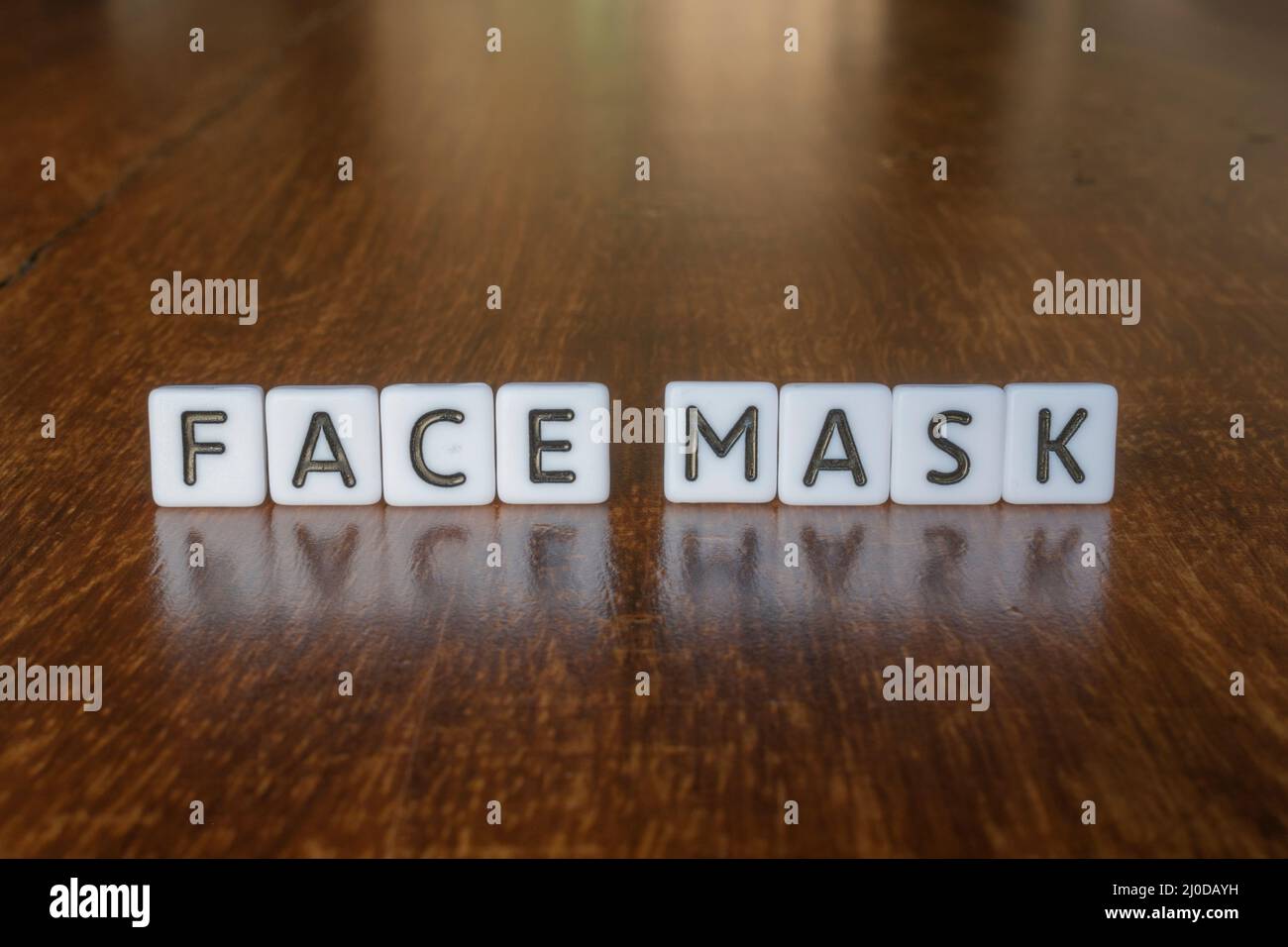 3D Face Mask message on wooden background with reflection Stock Photo ...