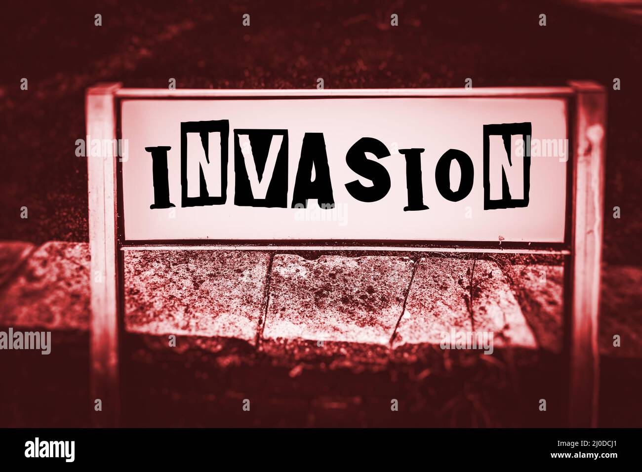 The word Invasion displayed on a street road sign with black text on a ...