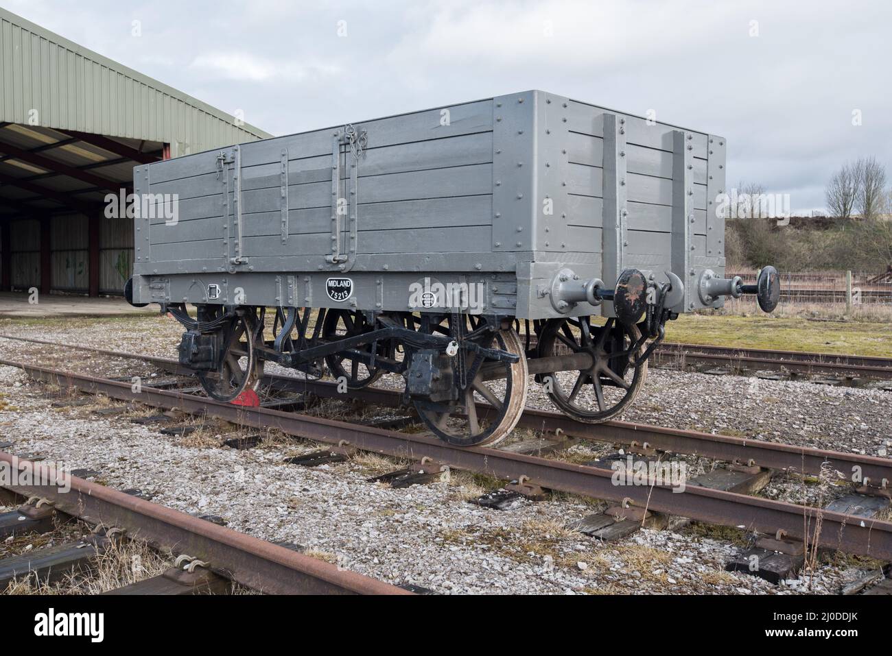 Wheel of carriage held by chock on line Stock Photo - Alamy