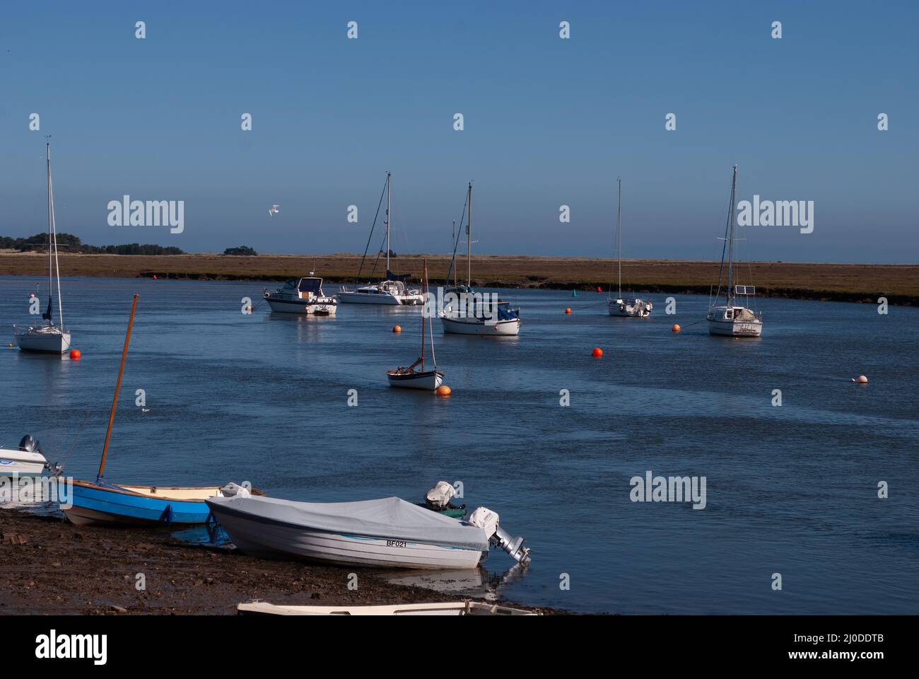 Small Boats floating on a wide river around dry field Stock Photo - Alamy