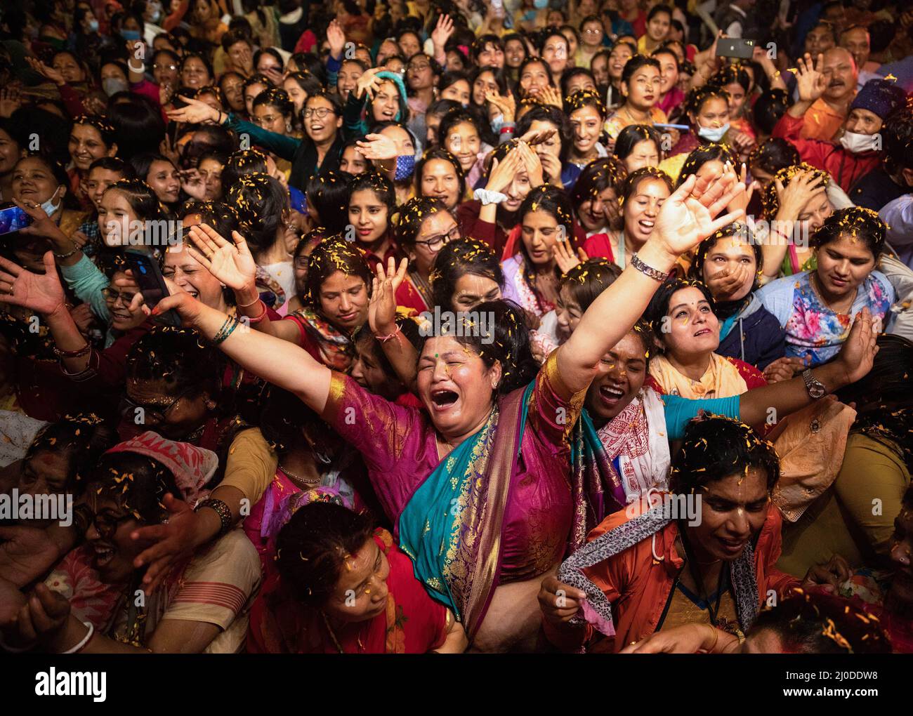 Kathmandu, Nepal. 18th Mar, 2022. Devotees sing and dance as flower ...