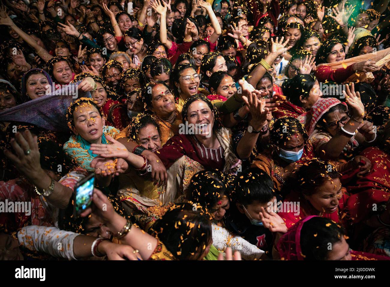 Devotees sing and dance as flower petals are thrown while celebrating ...