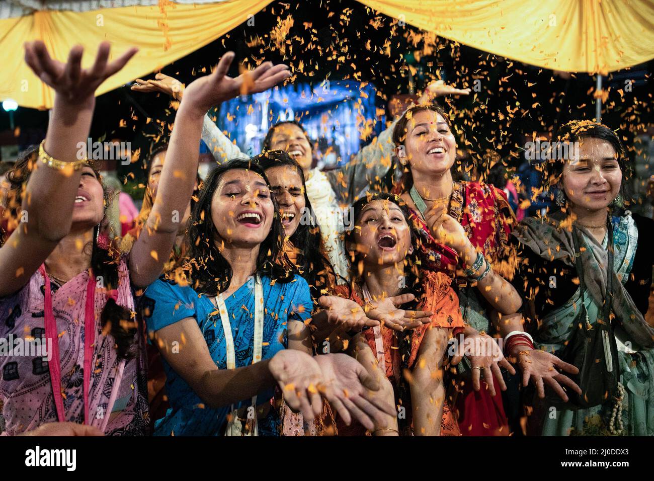 Kathmandu, Nepal. 18th Mar, 2022. Devotees sing and dance as flower ...