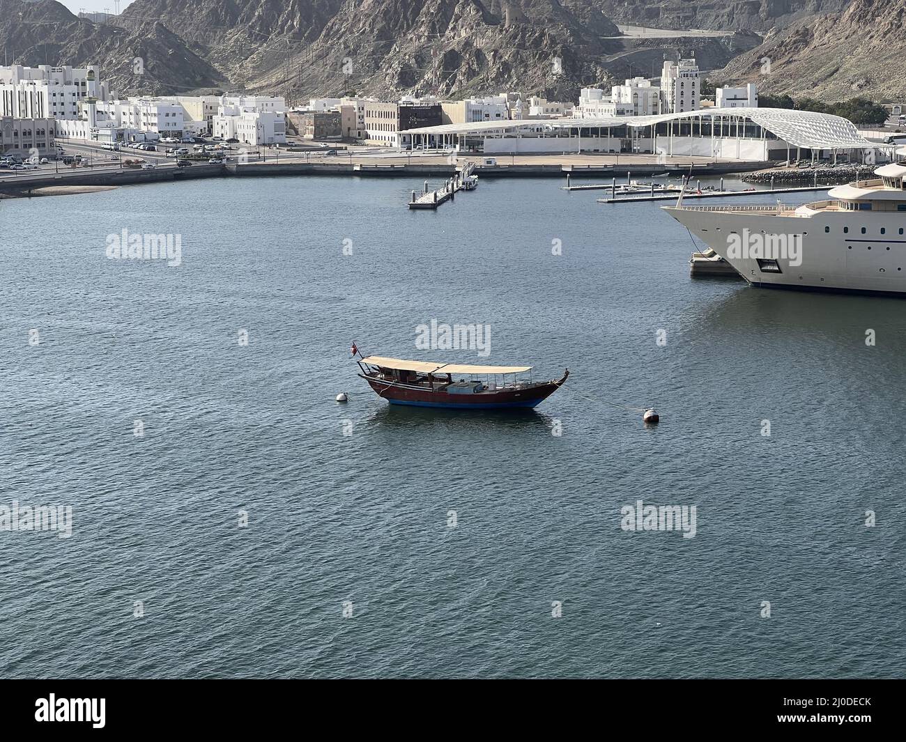 Old boat on the sea water in Muscat Corniche on a sunny day in Oman ...