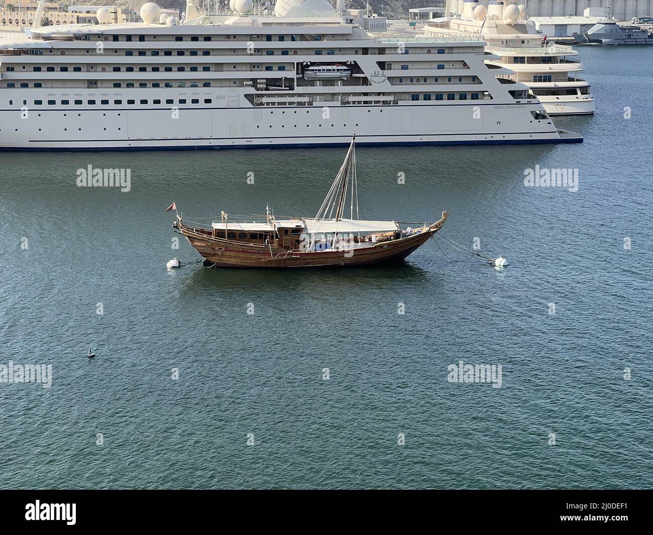 Old boat on the sea water in Muscat Corniche on a sunny day in Oman ...