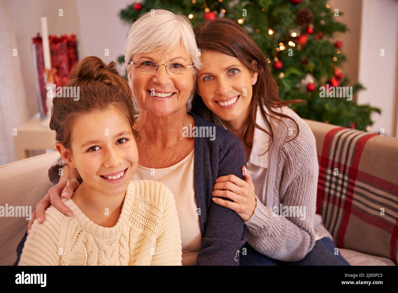 We wish you a Merry Christmas. Show of three-generations of a family ...