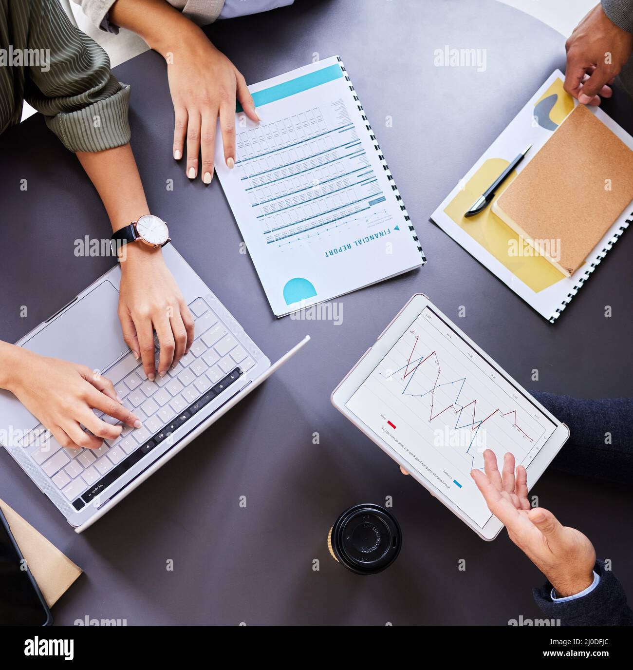 Tools and tricks of the trade. Shot of an office table with staff using ...