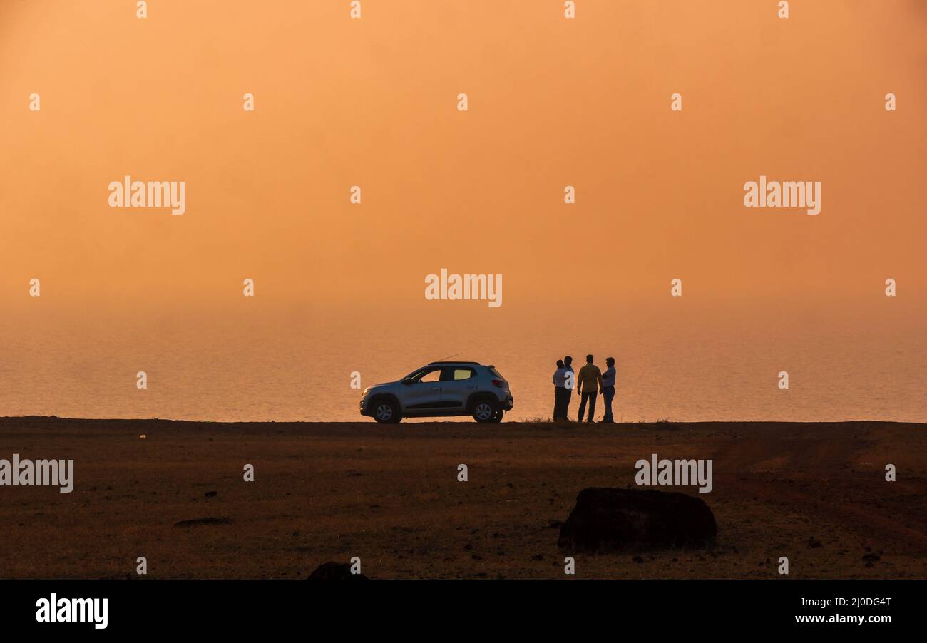 Sindhudurg, INDIA - December 23, 2021 : Silhouette of men and a car ...