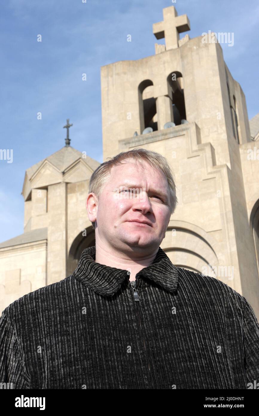 The man poses on a church background Stock Photo - Alamy