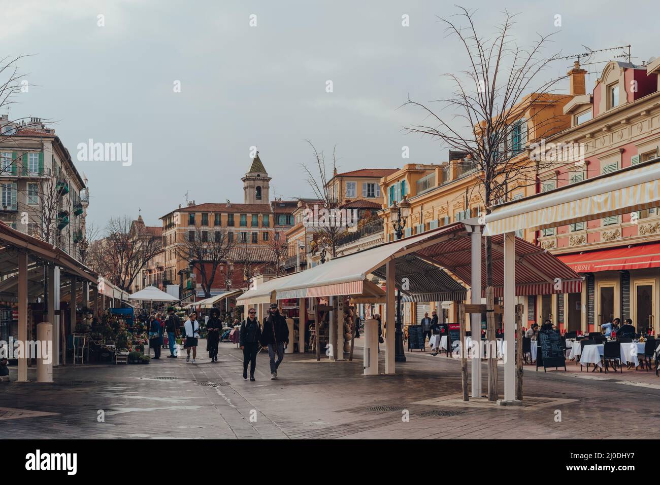 Nice, France - March 10, 2022: People walking past empty market stalls ...