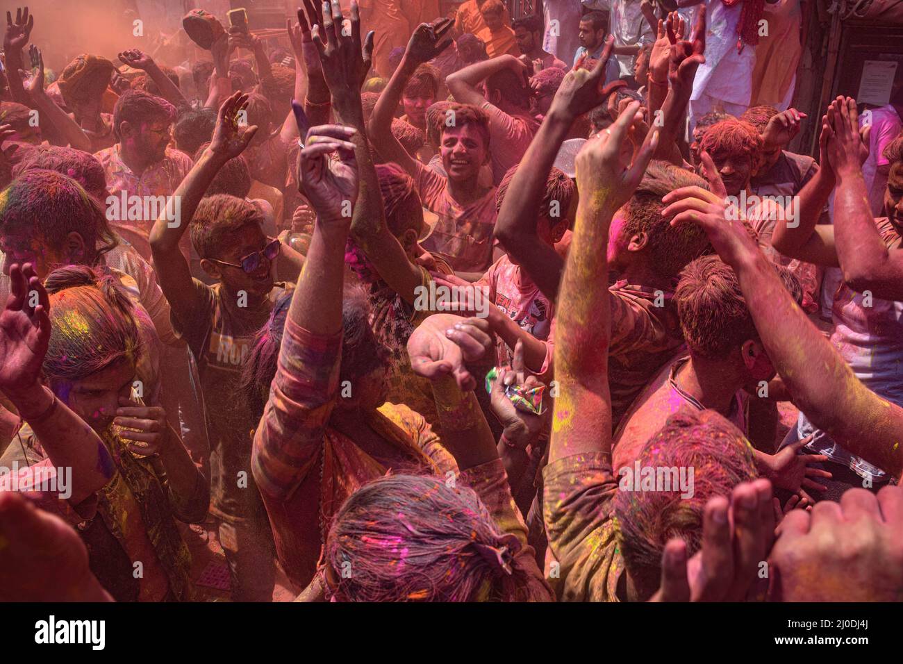 People are seen dancing during the Holi festival. Holi is a popular ...