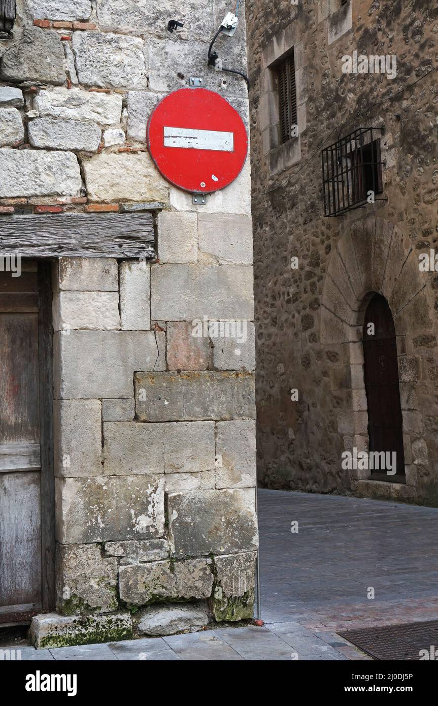 Vertical shot of the "no entry" road sign on the old building wall in ...