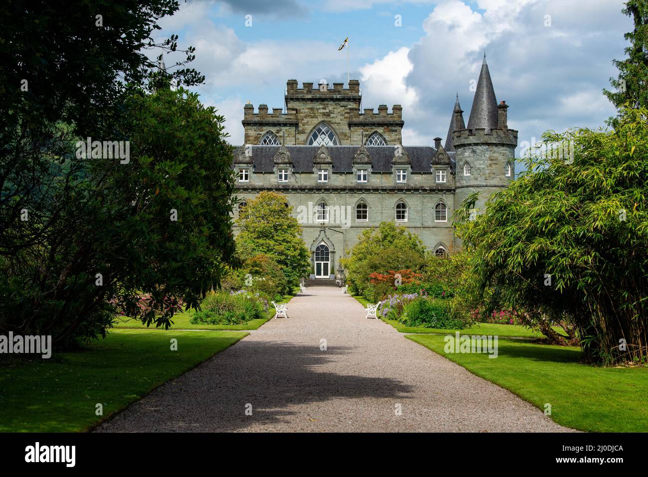 Beautiful way to Inveraray castle surrounded by green trees and bushes ...