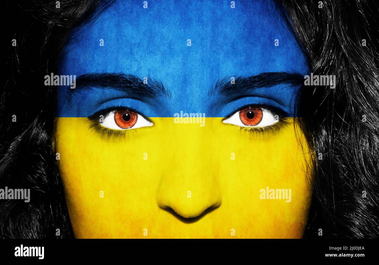 Woman face painted with the flag of Ukraine Stock Photo - Alamy