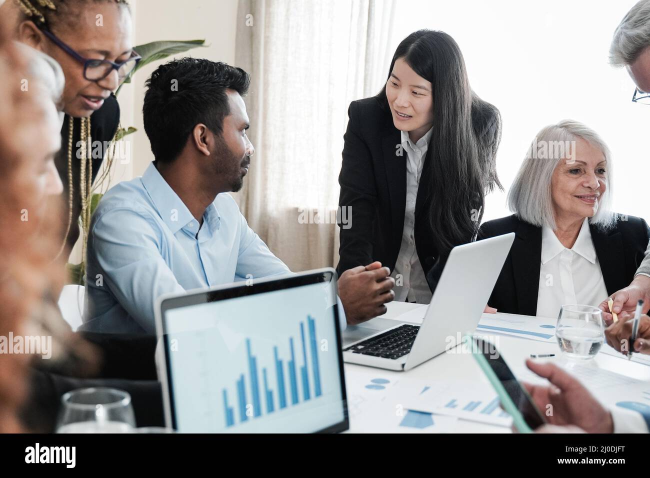 Multiracial business people working together inside modern bank office ...