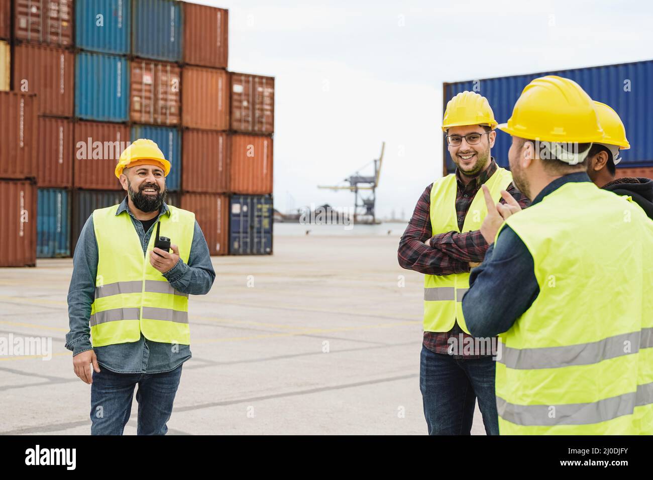 Multiracial industrial workers working inside international port ...