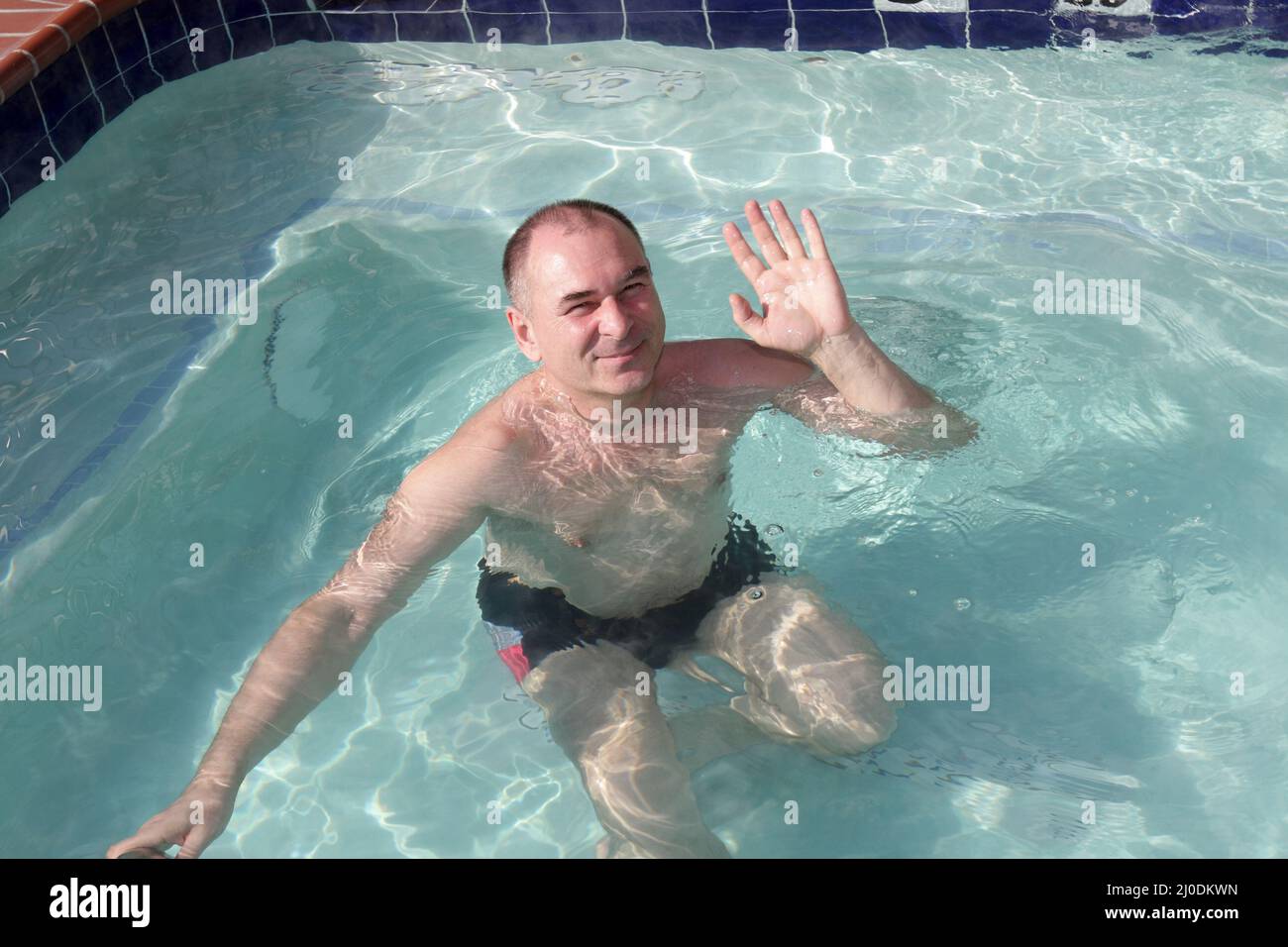 The man poses in a swimming pool Stock Photo - Alamy