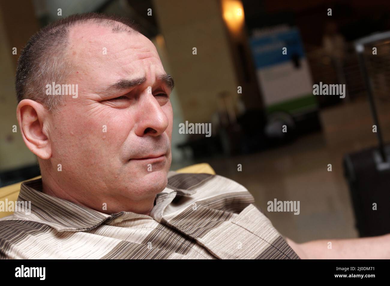 The sad man has finishing vacation in hotel Stock Photo - Alamy