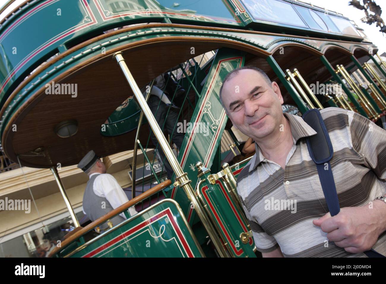 The man poses on a retro tram background Stock Photo - Alamy