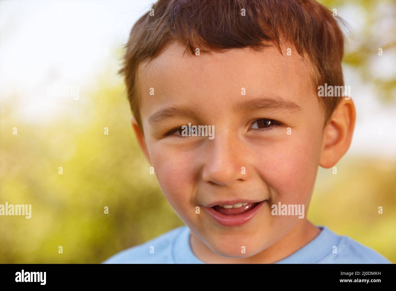 Child little boy portrait face laugh outside spring Stock Photo - Alamy
