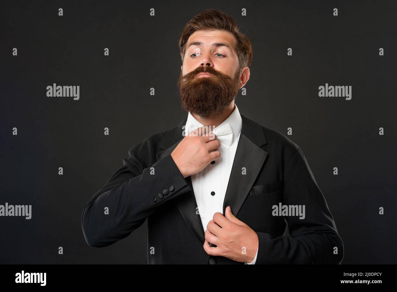 bearded groom in tuxedo on black background, suit Stock Photo - Alamy