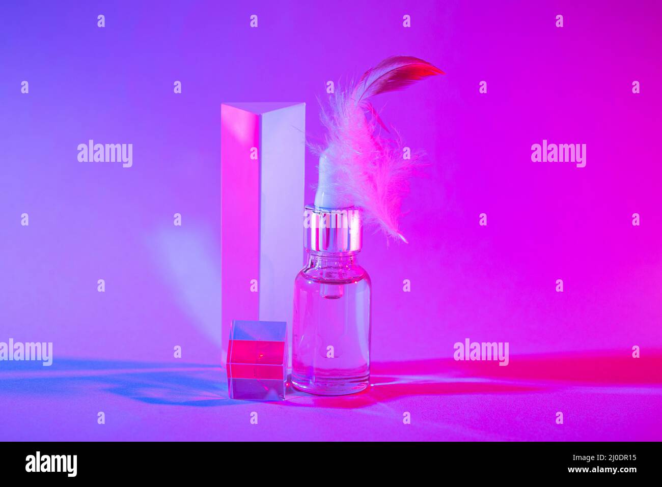 Bottle of cosmetic serum in neon light Stock Photo - Alamy