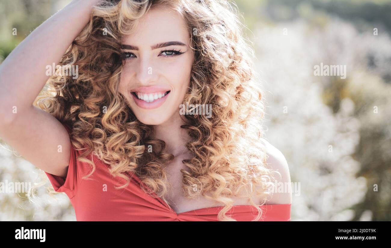 Spring girl with curly hair smiling. Beauty hair Salon. Beauty girl ...