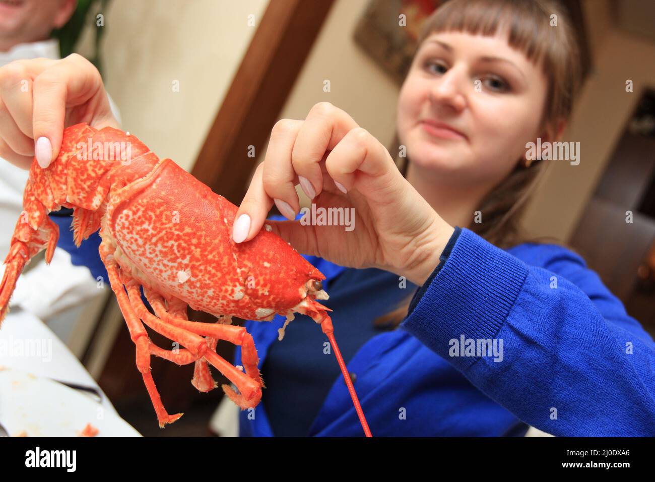The girl eats a lobster in a restaurant Stock Photo - Alamy