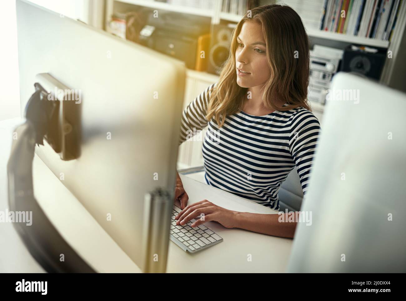 Dedicated to her business. High angle shot of a young woman working on ...