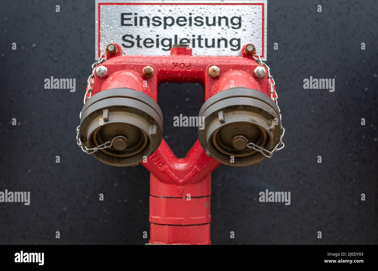 Red fire hydrant in front of the old wall Stock Photo - Alamy
