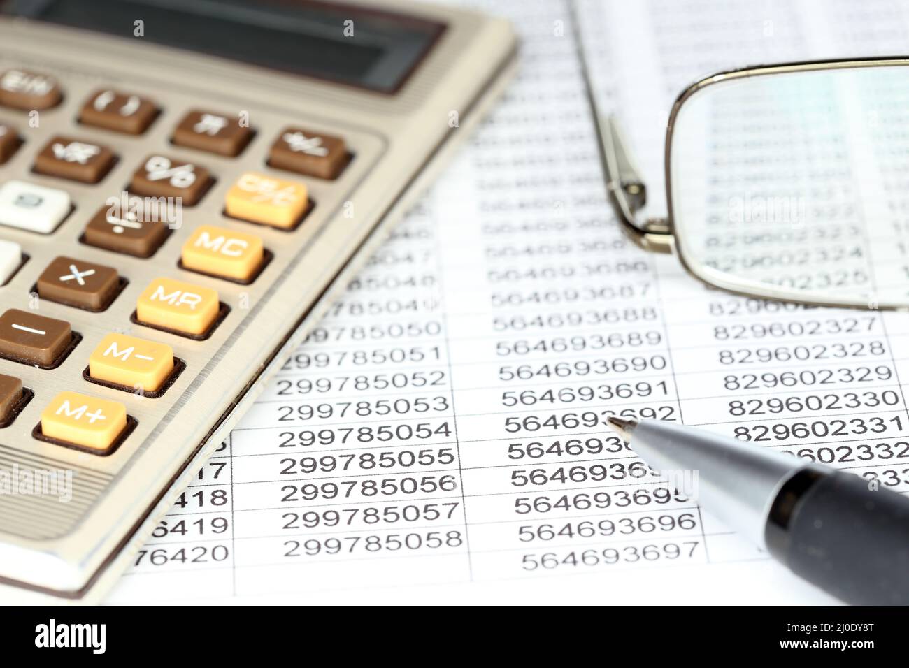 Calculator with pen and eyeglasses Stock Photo - Alamy