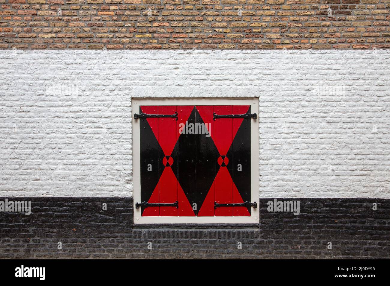 Red warning sign on brick wall Stock Photo - Alamy