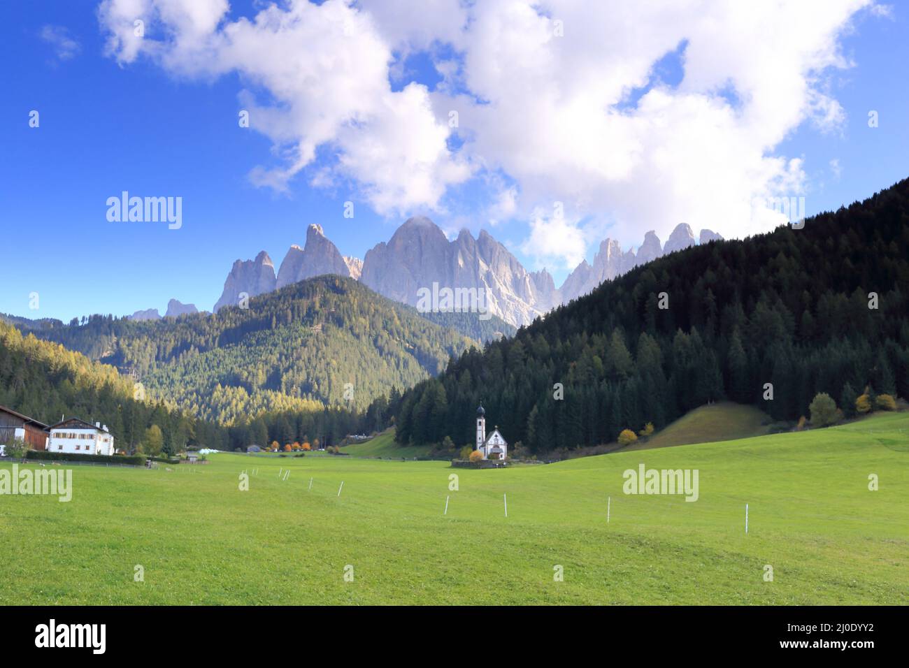Beautiful landscape with church and some mountain peaks at sundown ...