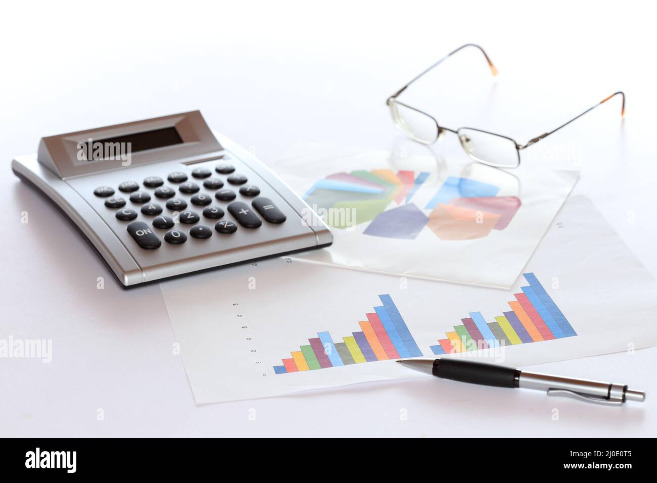 Charts and calculator on table Stock Photo - Alamy