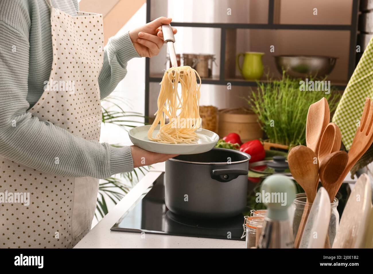 Woman putting spaghetti pot hi-res stock photography and images - Alamy