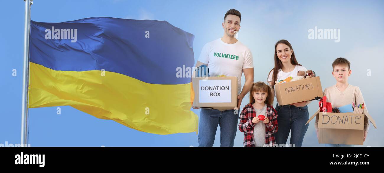 Family of volunteers with donation boxes and Ukrainian flag against ...